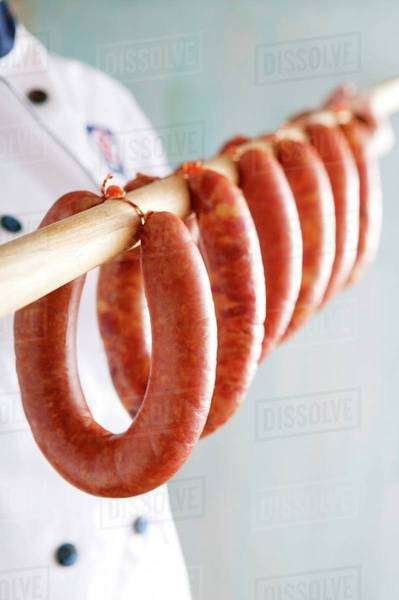 Dutch rookworst hanging on a stick - Royalty-free Stock Photo | Dissolve