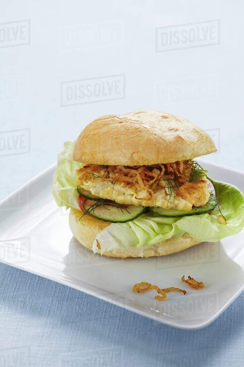 A hake burger with yoghurt and roasted onions - Royalty-free Stock ...