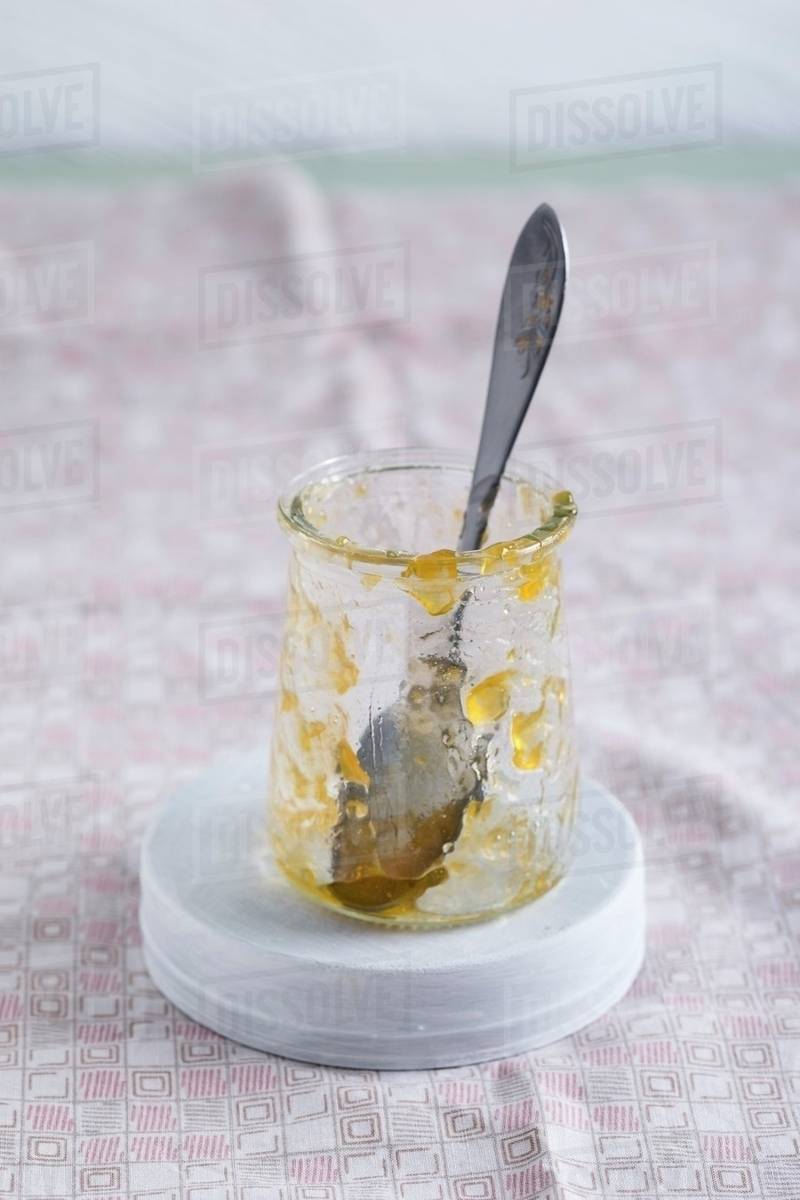 An empty jam jar with the remains of apricot jam - Royalty-free Stock ...