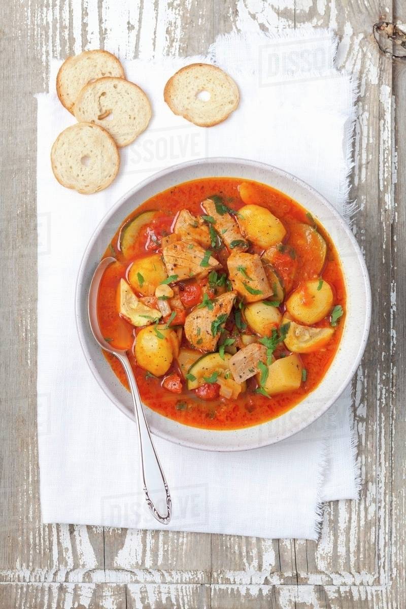Braised tuna with potatoes and courgette in tomato sauce - Stock Photo ...