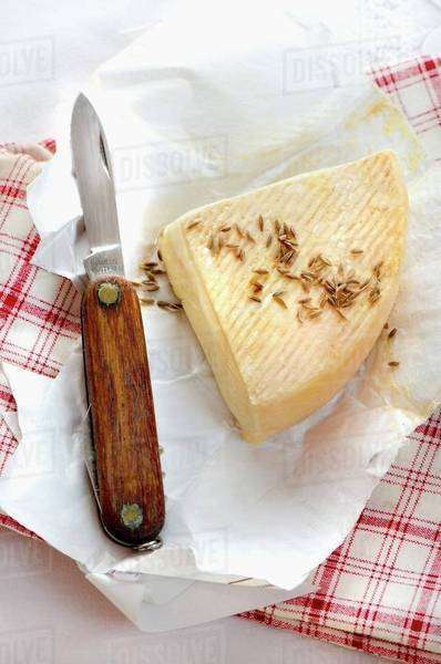 A slice of Alsatian Munster cheese - Royalty-free Stock Photo | Dissolve