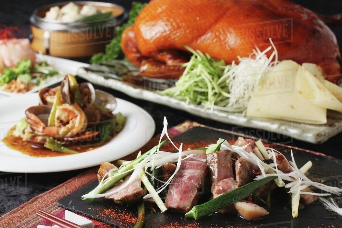 A Chinese buffet featuring grilled beef, Peking duck and prawns with ...