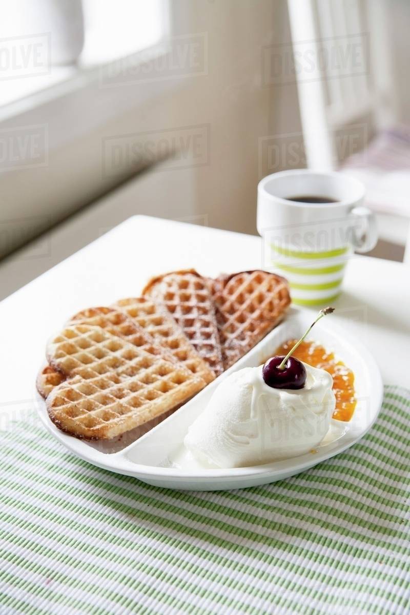 Heart-shaped waffles with vanilla ice cream and cloudberry jam ...