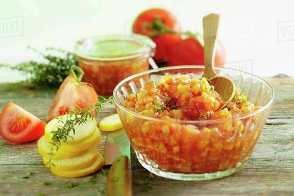 Courgette and tomato chutney with ingredients - Stock Photo - Dissolve