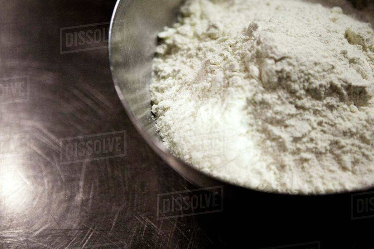 Wheat flour in a mixing bowl - Stock Photo - Dissolve