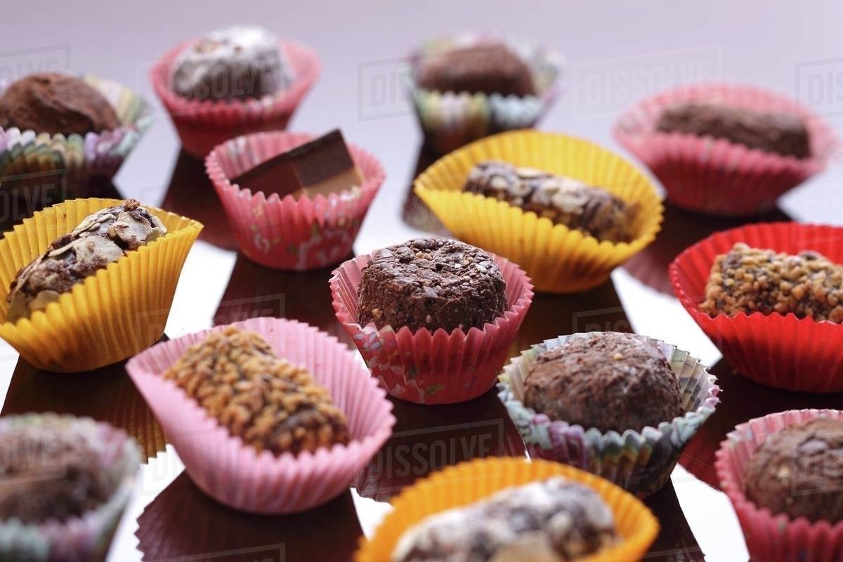 Assorted filled chocolates in colourful paper cases - Royalty-free ...