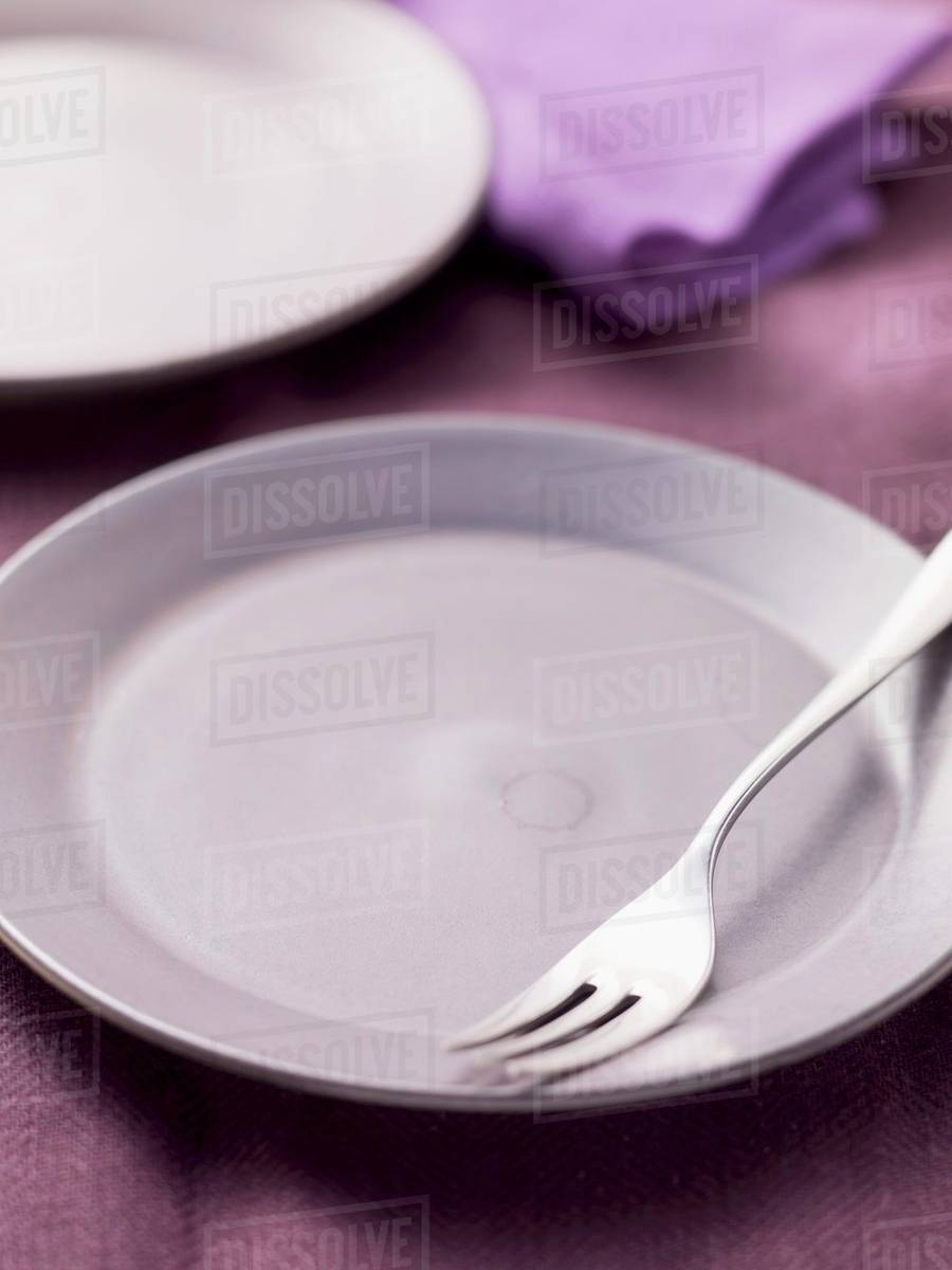 An empty plate with a dessert fork - Royalty-free Stock Photo | Dissolve