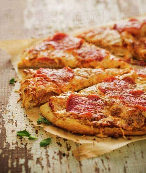 Sliced Pepperoni Pizza on Parchment Paper - Royalty-free Stock Photo ...