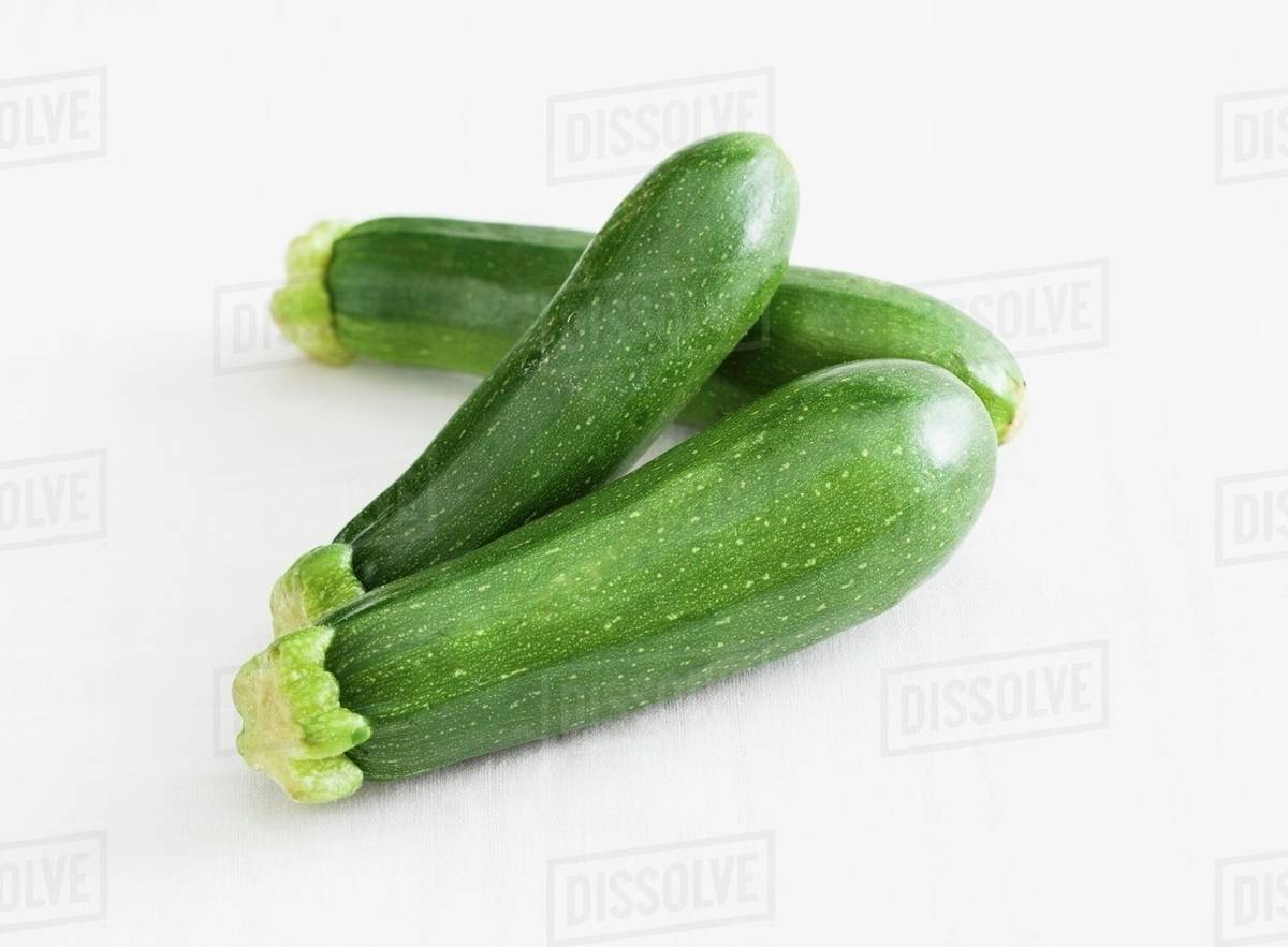 Three courgettes against a white background - Royalty-free Stock Photo ...