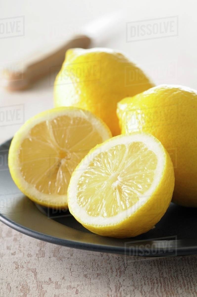 A whole lemon and a halved lemon - Royalty-free Stock Photo | Dissolve
