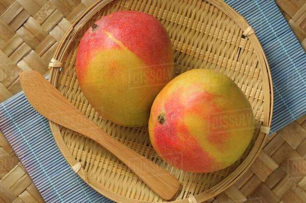 Two mangos in a basket - Royalty-free Stock Photo | Dissolve