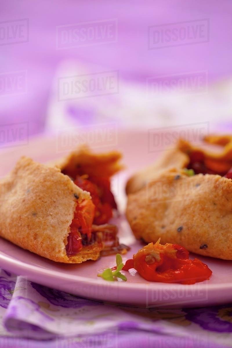 Wholemeal pastry parcels with pepper and onion filling, halved ...