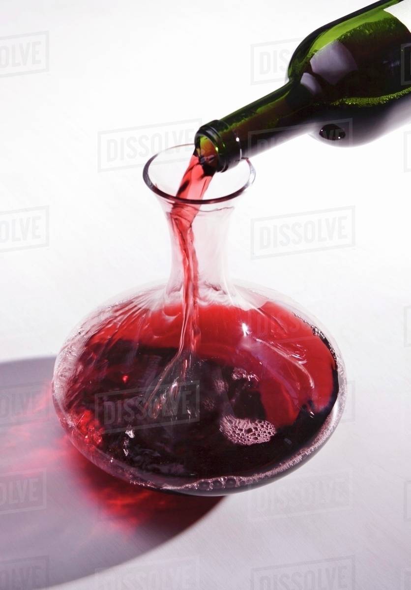 Red wine being decanted - Royalty-free Stock Photo | Dissolve
