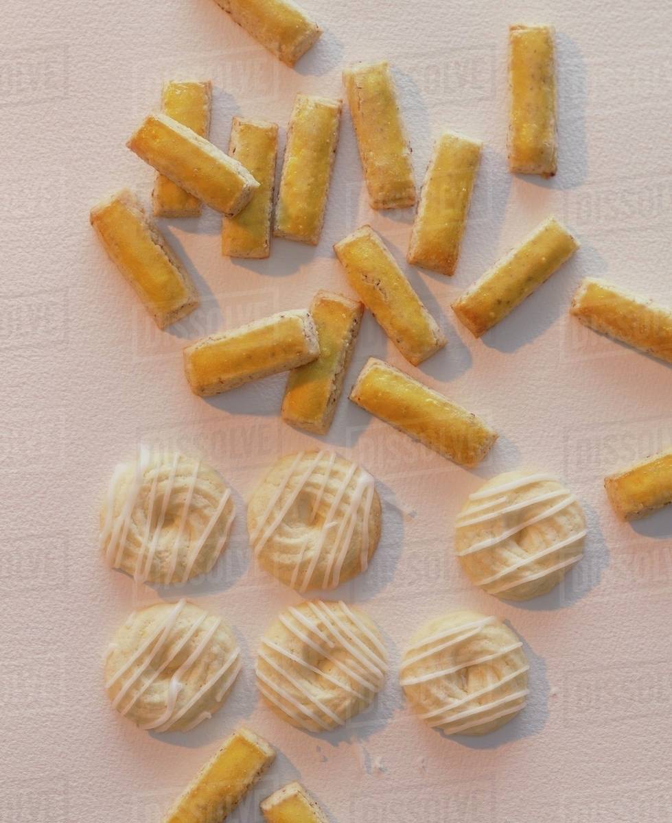 Piped biscuits and almond batons - Stock Photo - Dissolve