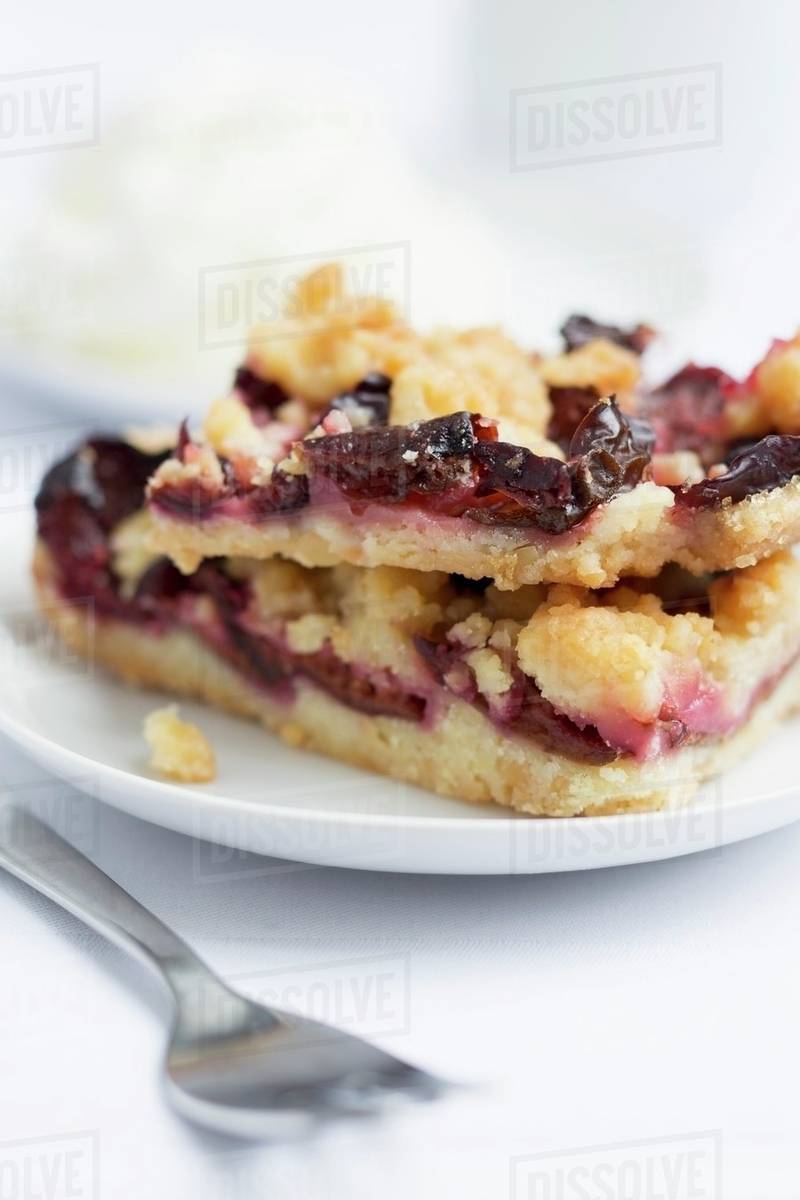 Two slices of plum crumble cake - Royalty-free Stock Photo | Dissolve