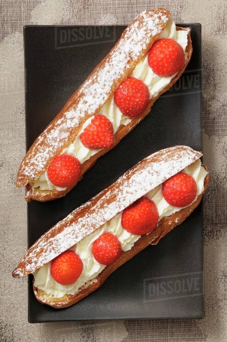 Eclairs with cream and strawberries - Royalty-free Stock Photo | Dissolve