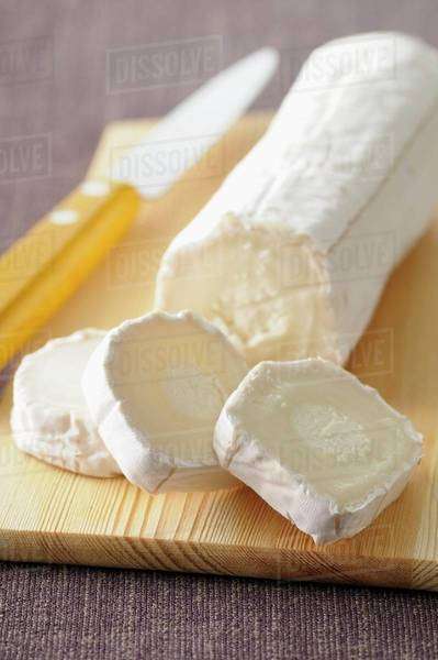 Slice of Goats Cheese with Goat Cheese Log - Royalty-free Stock Photo ...