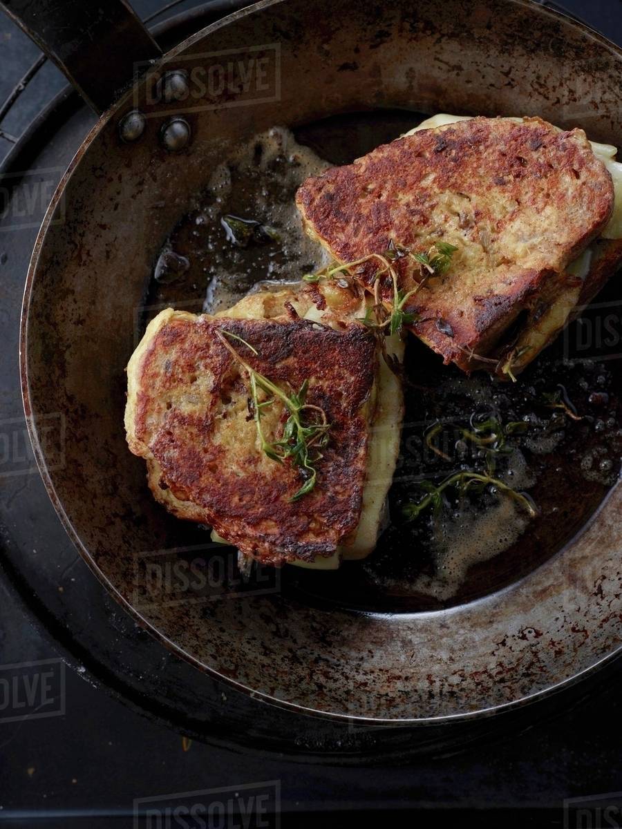 Rustic cheese on toast in an old frying pan - Royalty-free Stock Photo ...