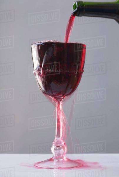 Red Wine Bering Over Poured - Stock Photo - Dissolve