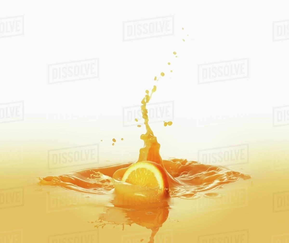 Orange slice falling into orange juice - Royalty-free Stock Photo ...