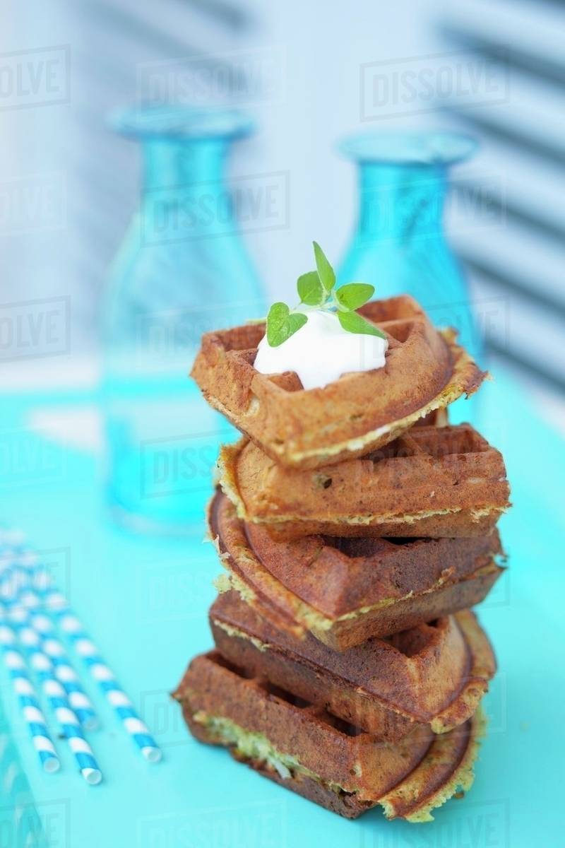 Triangular courgette waffles with yoghurt and mint leaves - Royalty ...
