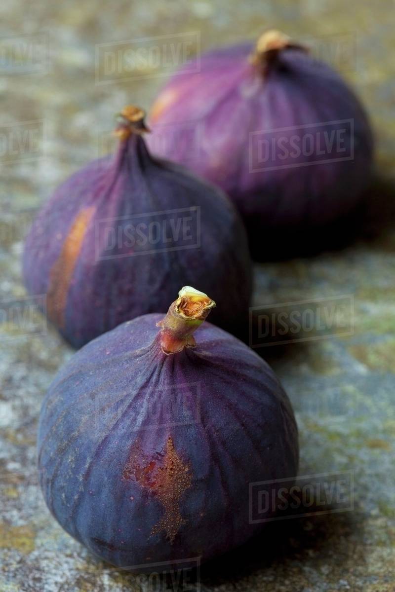 Three fresh red figs - Stock Photo - Dissolve