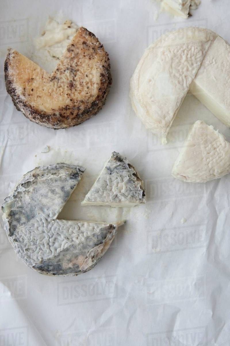 Three Assorted Goat Cheese Wheels; Each with a Wedge Removed; From ...