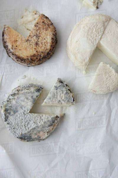 Three Assorted Goat Cheese Wheels; Each with a Wedge Removed; From ...