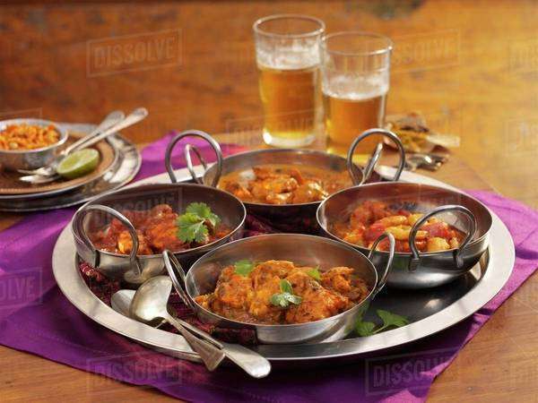 Four different types of curries on a tray - Stock Photo - Dissolve
