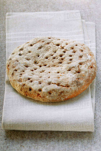 Rustic flatbread on linen cloth - Stock Photo - Dissolve