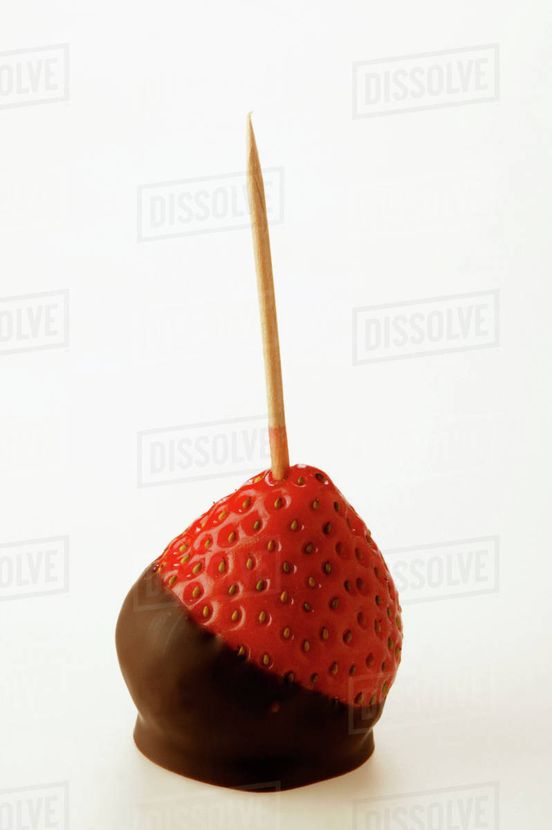 Chocolate-coated strawberry on toothpick - Royalty-free Stock Photo ...