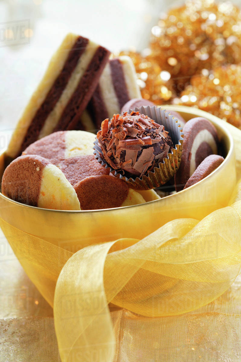 Two-colour cookies and chocolate truffles - Stock Photo - Dissolve