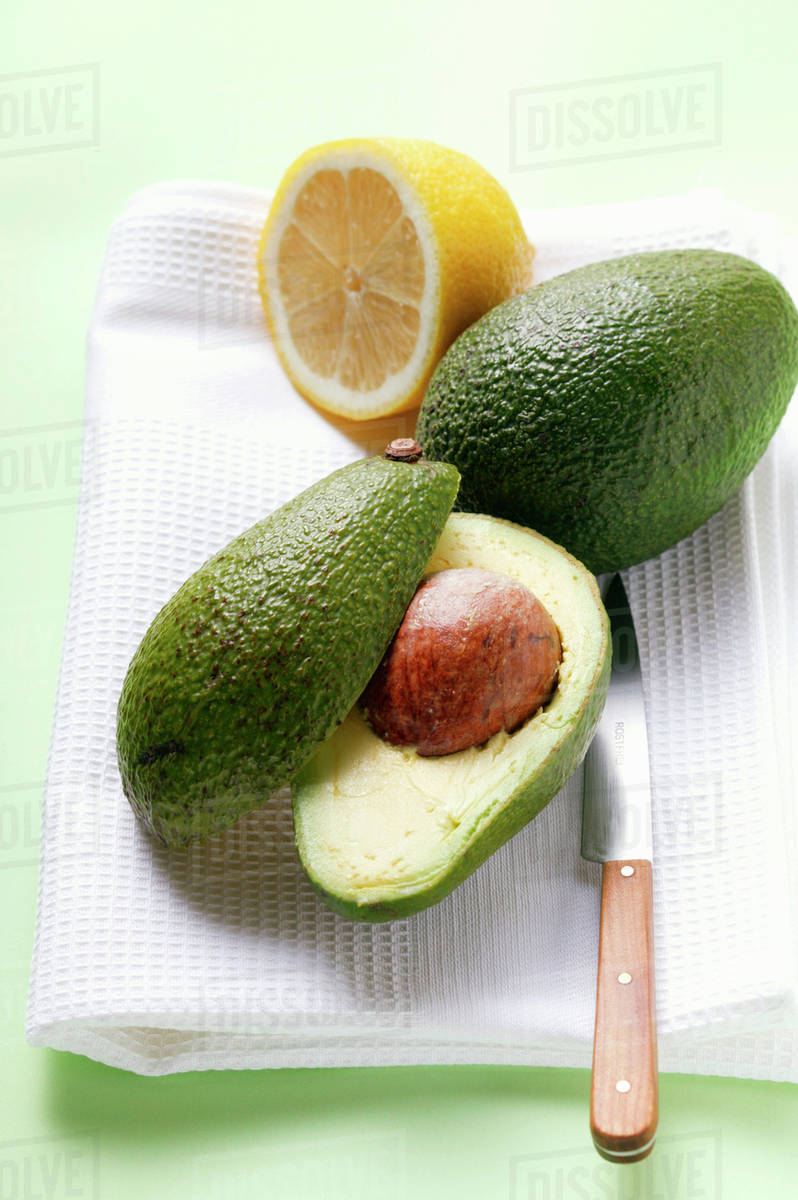 Avocados, whole and halved, with lemon - Royalty-free Stock Photo ...