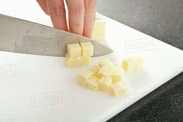 Hands Cutting Cheddar Cheese Into Cubes - Royalty-free Stock Photo ...
