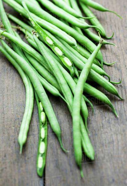 Green beans on a wooden background - Stock Photo - Dissolve