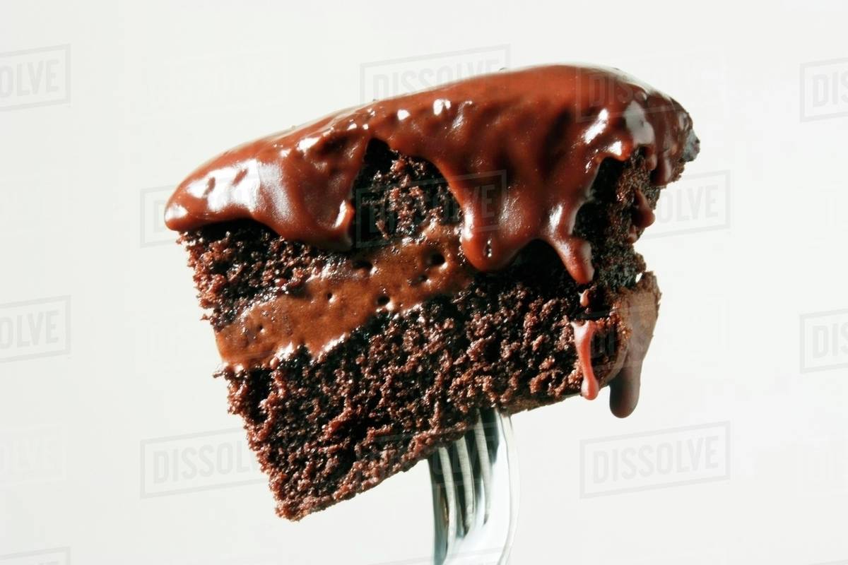 Piece of Chocolate Cake with Chocolate Frosting on a Fork - Royalty ...