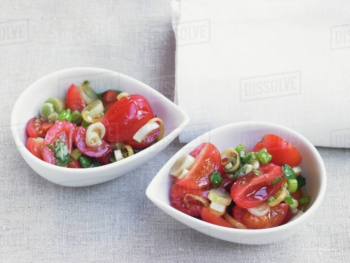 Bowls of tomato salsa with spring onions - Stock Photo - Dissolve