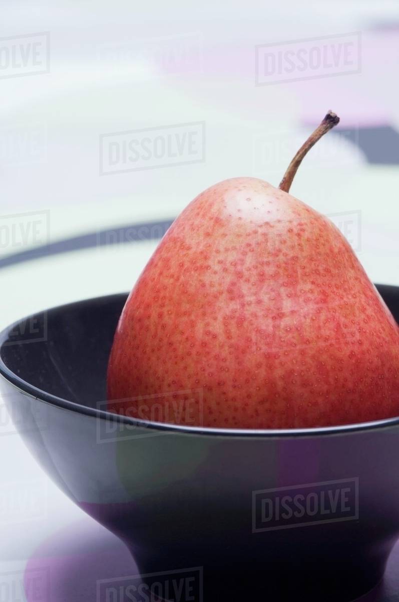 A pear in a bowl - Royalty-free Stock Photo | Dissolve