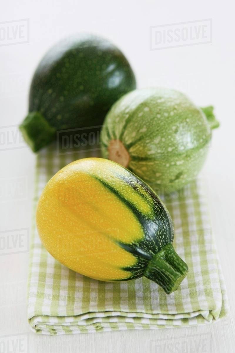 Mini courgettes in three colours on a tea towels - Royalty-free Stock ...