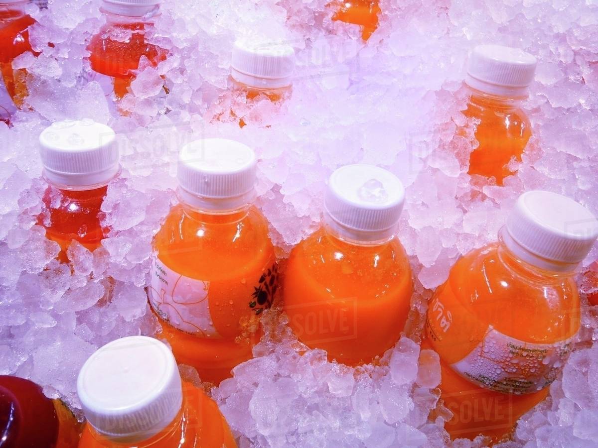 Bottles of freshly pressed fruit juice on ice - Royalty-free Stock ...