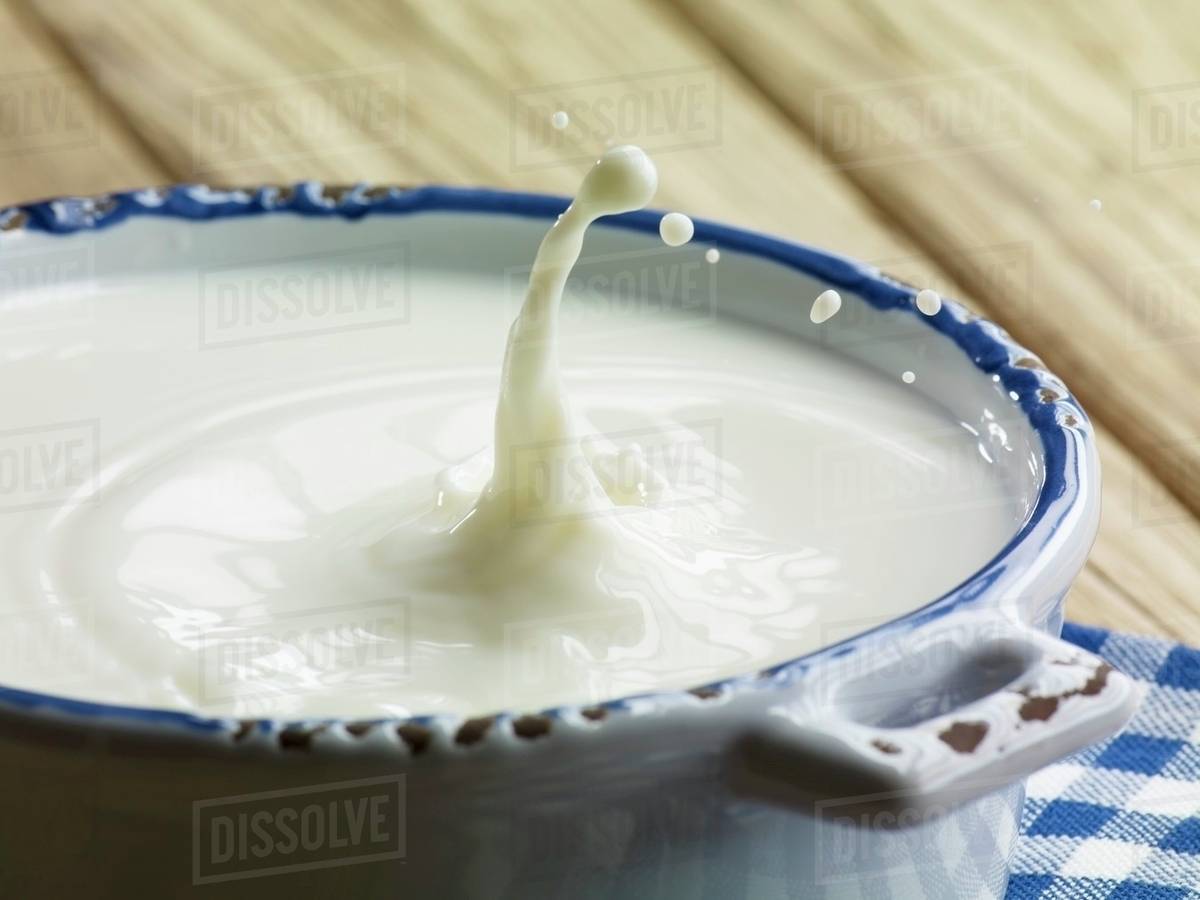 Milk splashing out of a bowl - Royalty-free Stock Photo | Dissolve