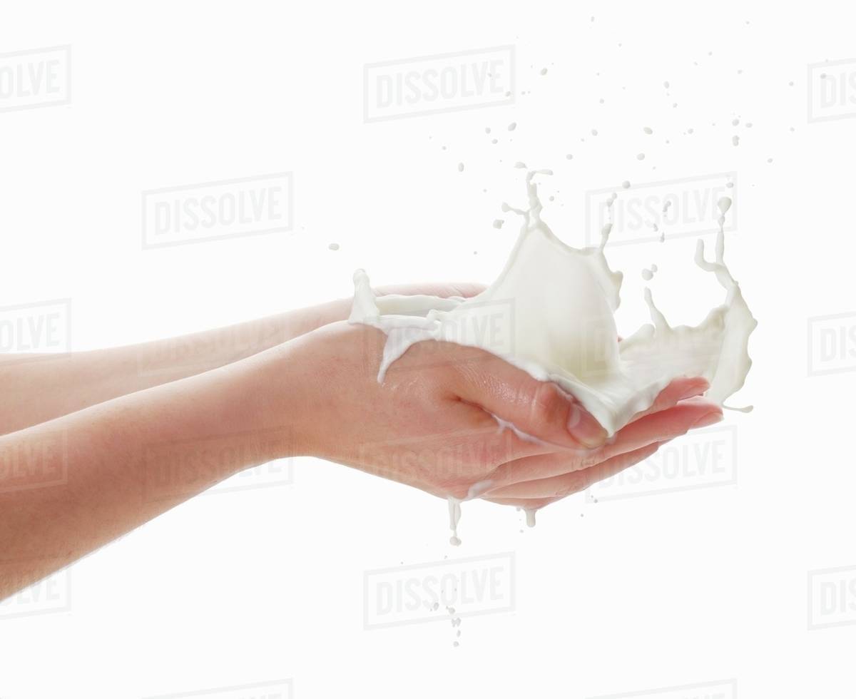 Hands with a milk splash - Royalty-free Stock Photo | Dissolve