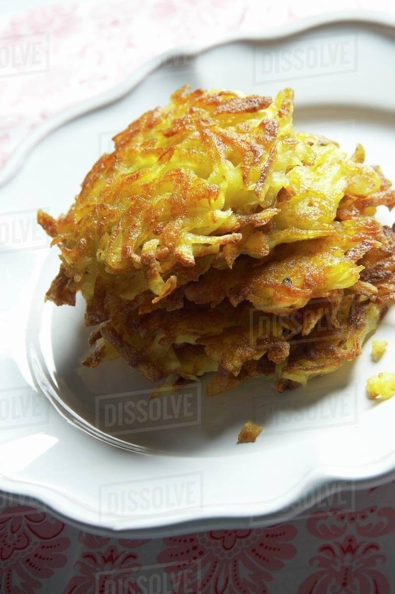 A stack of potato rosti (hash browns) on a plate - Royalty-free Stock ...