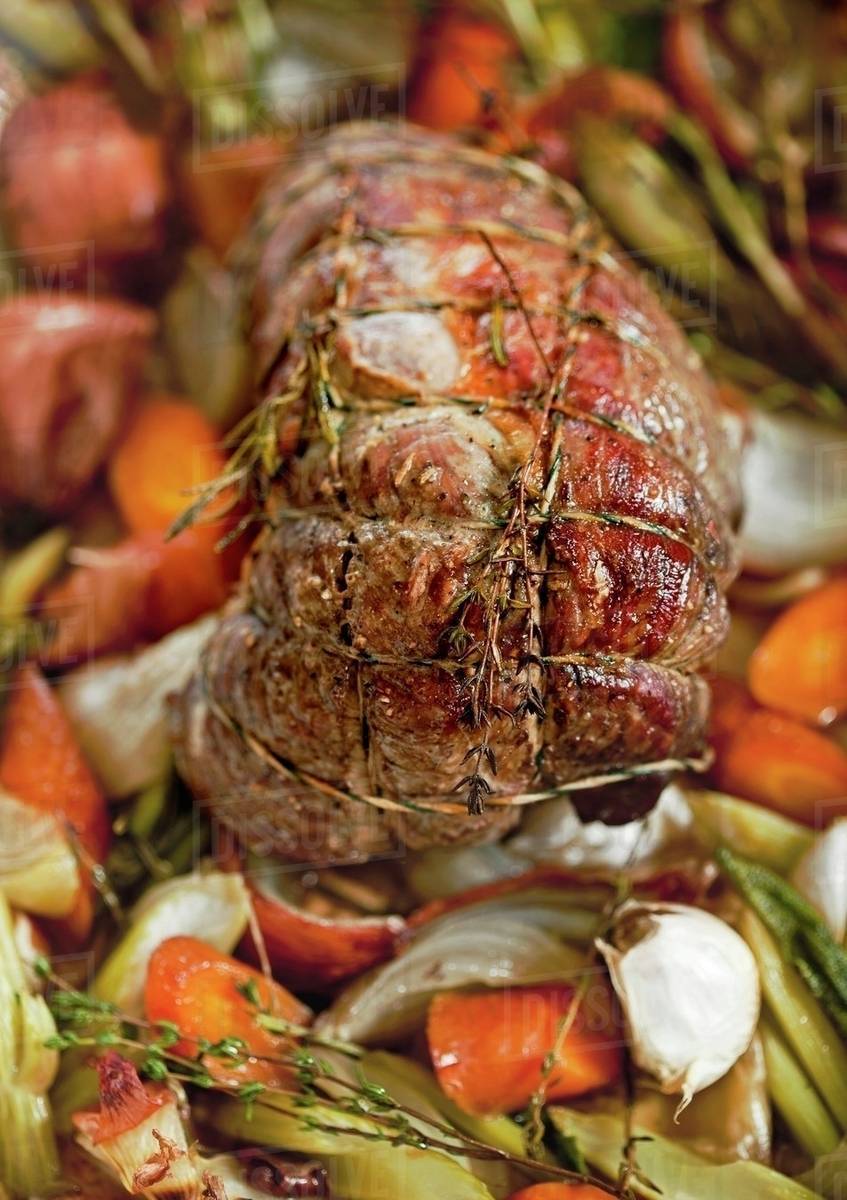 Beef shoulder fillet with herbs on a bed of vegetables - Royalty-free ...