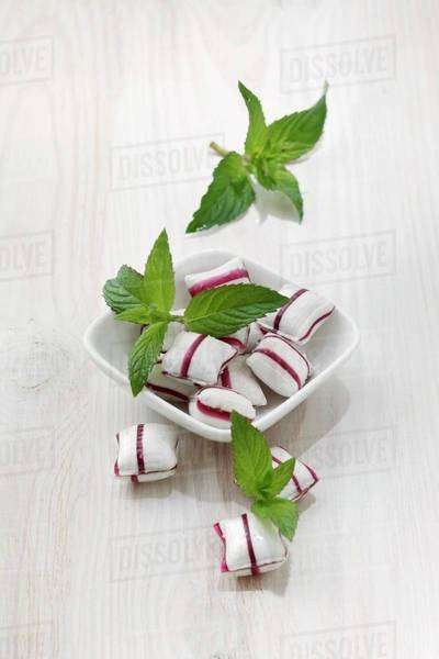 Peppermint bonbons and fresh mint - Royalty-free Stock Photo | Dissolve