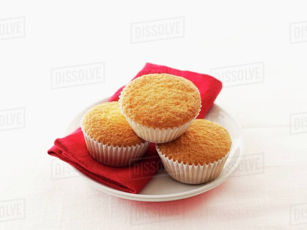 Three muffins on a plate - Royalty-free Stock Photo | Dissolve