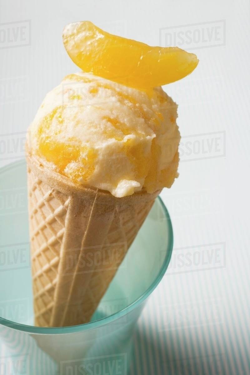 Orange ice cream in wafer cone in a beaker - Royalty-free Stock Photo ...