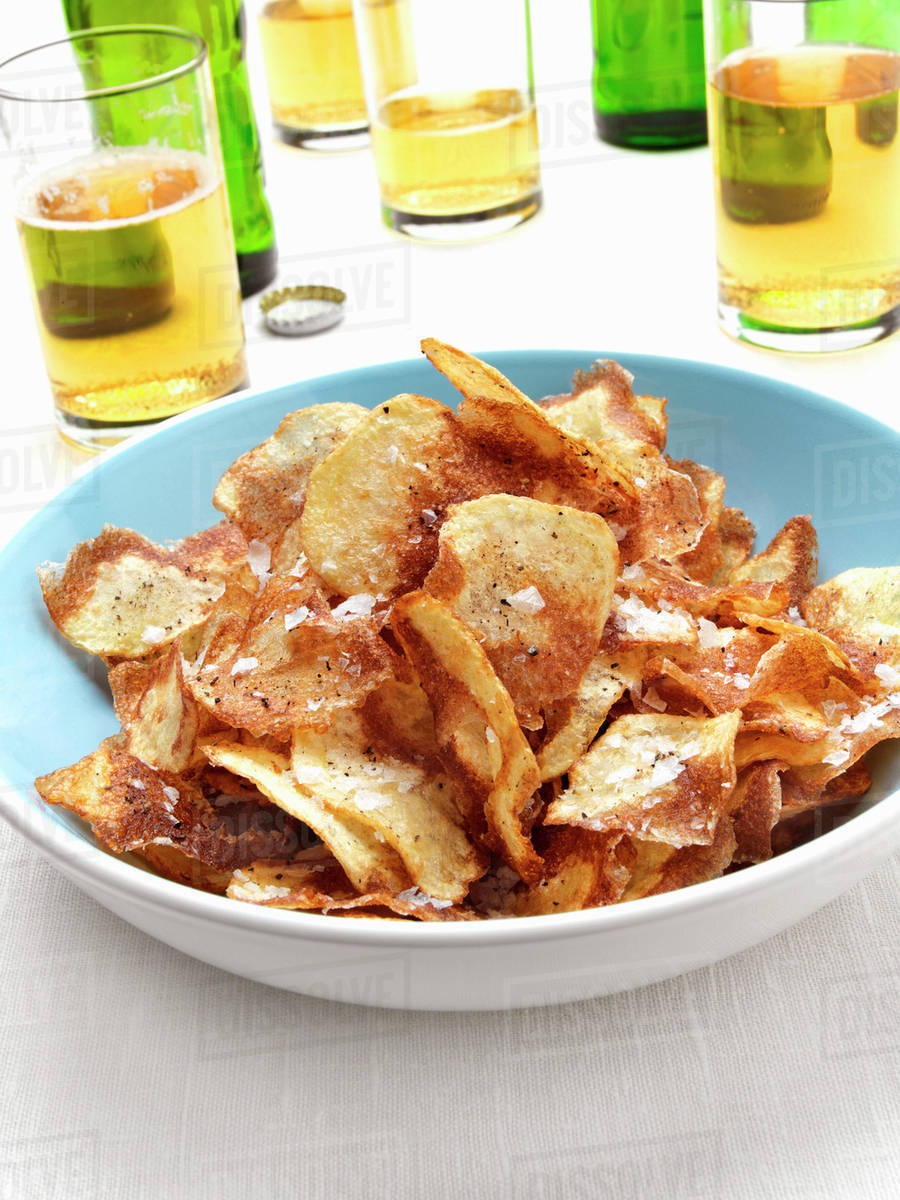 Home-made potato crisps; beer - Royalty-free Stock Photo | Dissolve