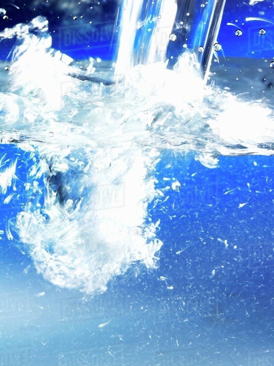 Jet of water entering water - Royalty-free Stock Photo | Dissolve