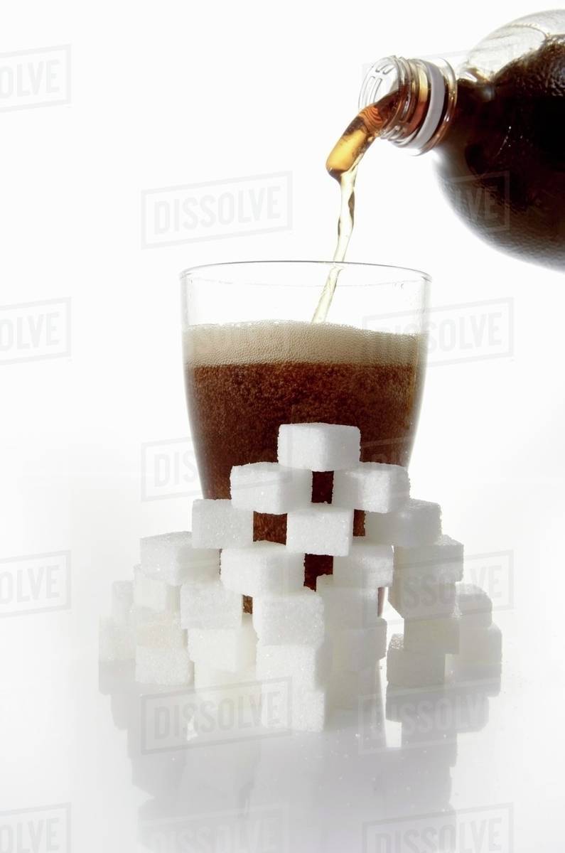 Cola & sugar cubes (picture symbolising high sugar content) - Royalty ...